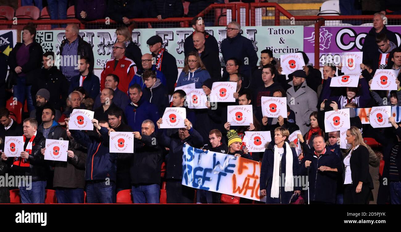 Brentford fans hold up 'Lest We Forget' signs during the two minute ...