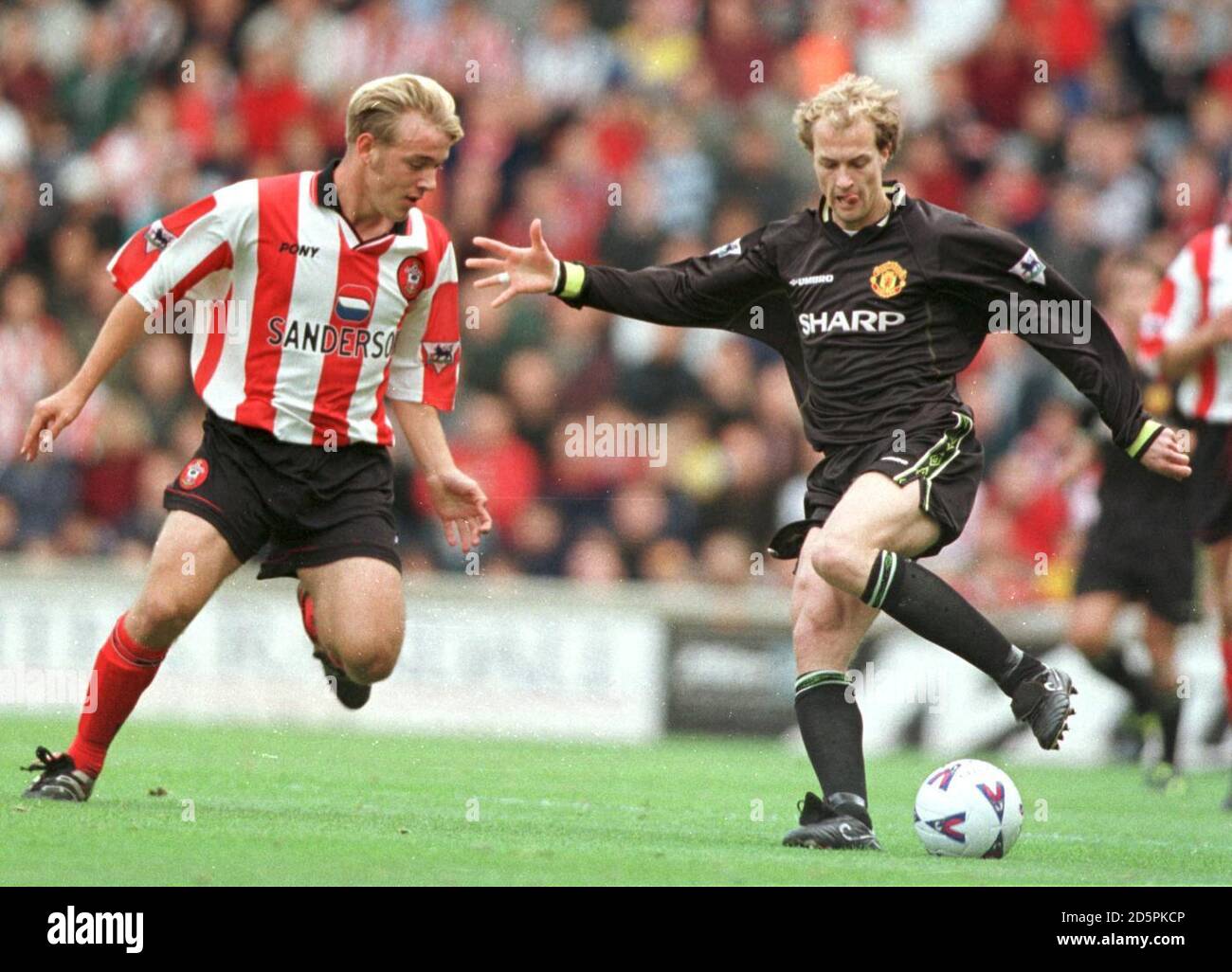Southampton's Kevin Gibbens (left) keeps a close eye on Manchester ...