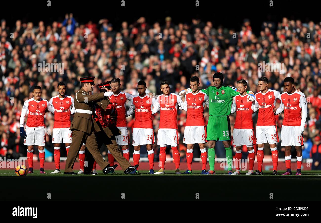 Arsenal players stand arm-in-arm before the game to remember the ...
