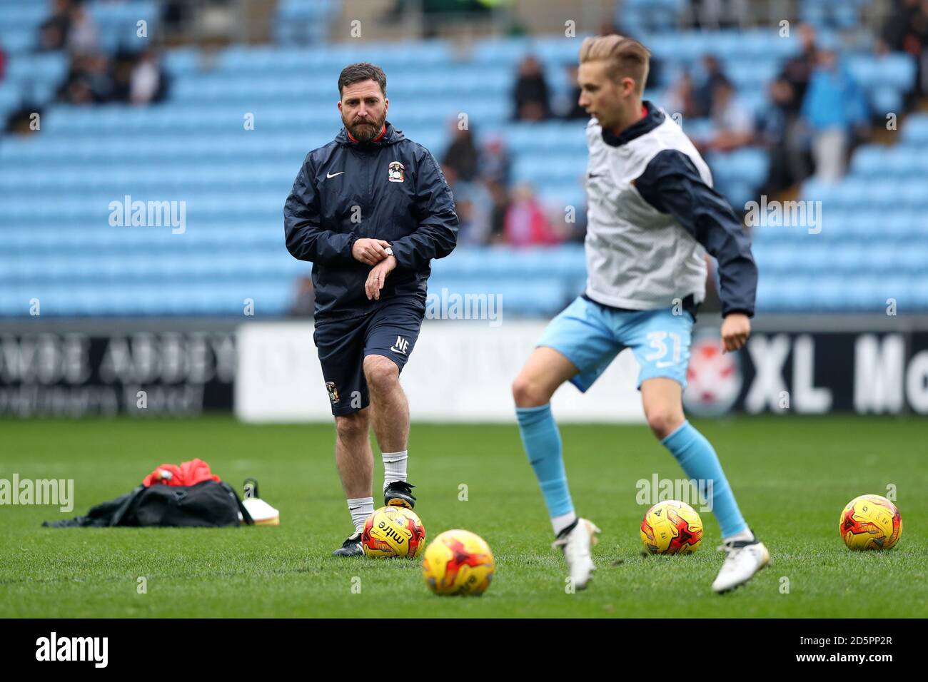 Coventry City First Team coach Nicky Eaden (left) watches over the warm ...