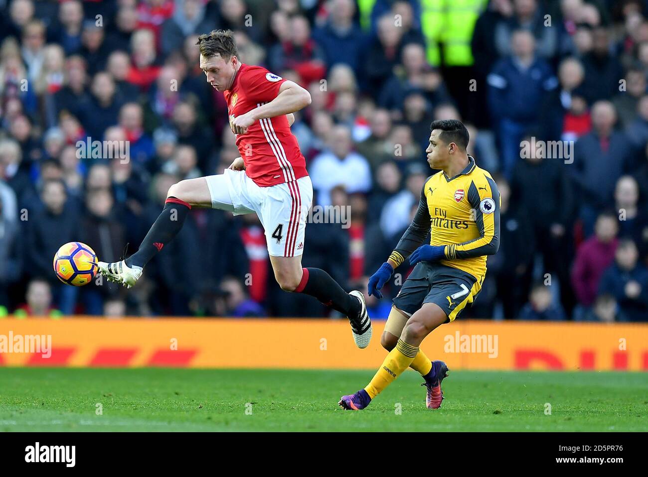 Manchester United's Phil Jones (left) and Arsenal's Alexis Sanchez ...