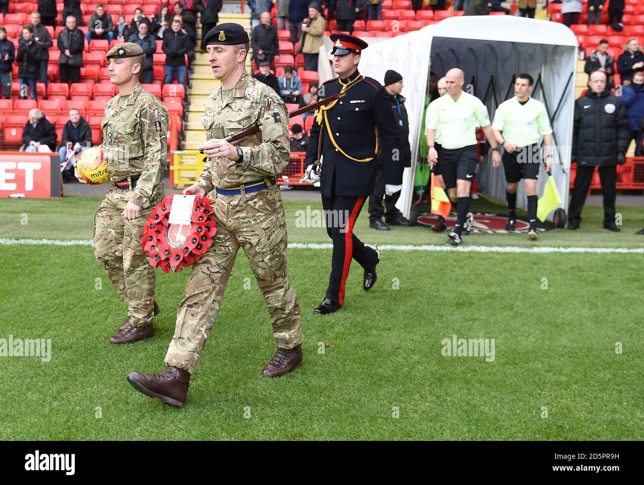 The teams are lead out by soldiers to honour Remembrance Sunday Stock ...