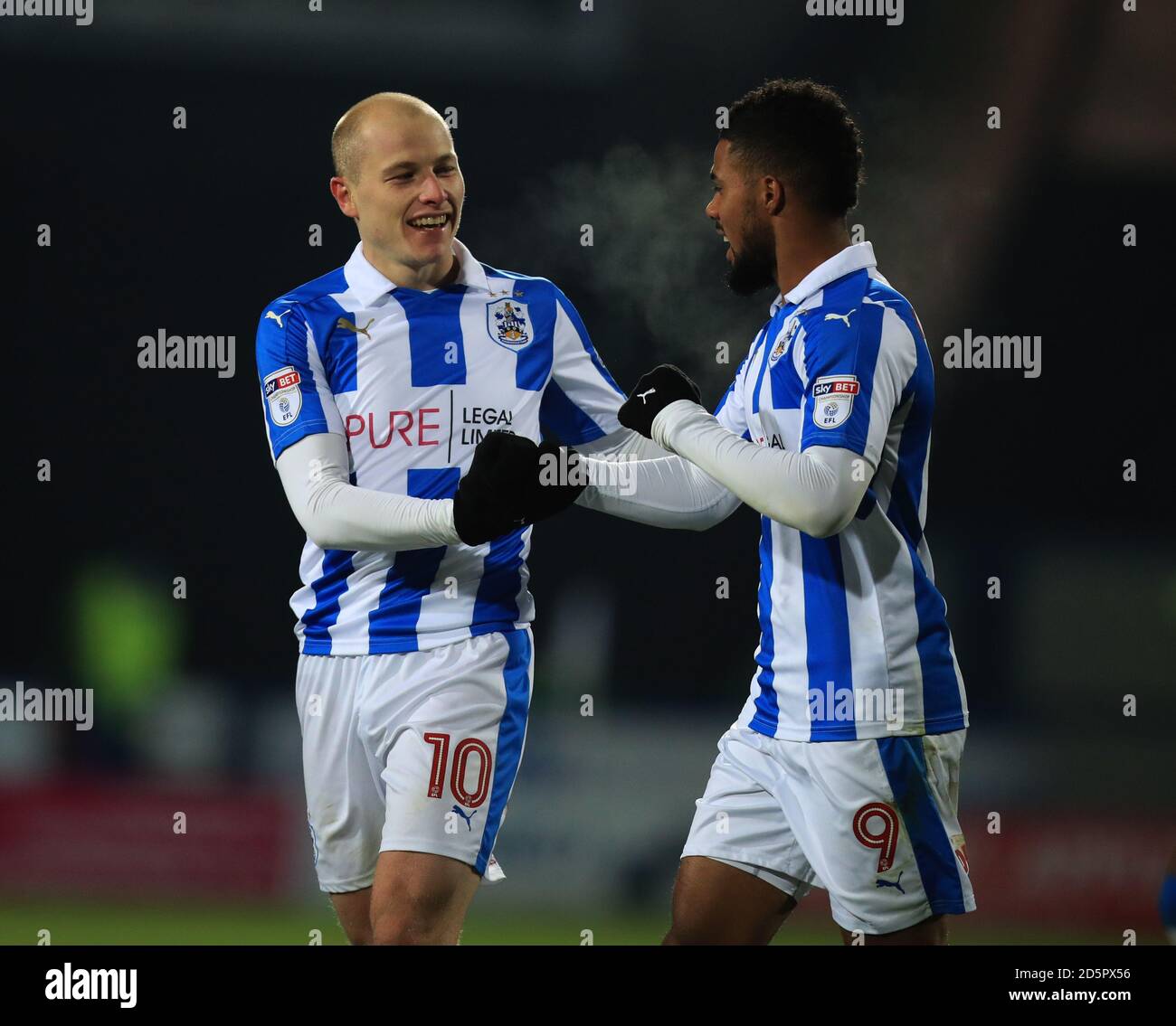 Huddersfield Town's Aaron Mooy (left) celebrates his goal with Elias ...