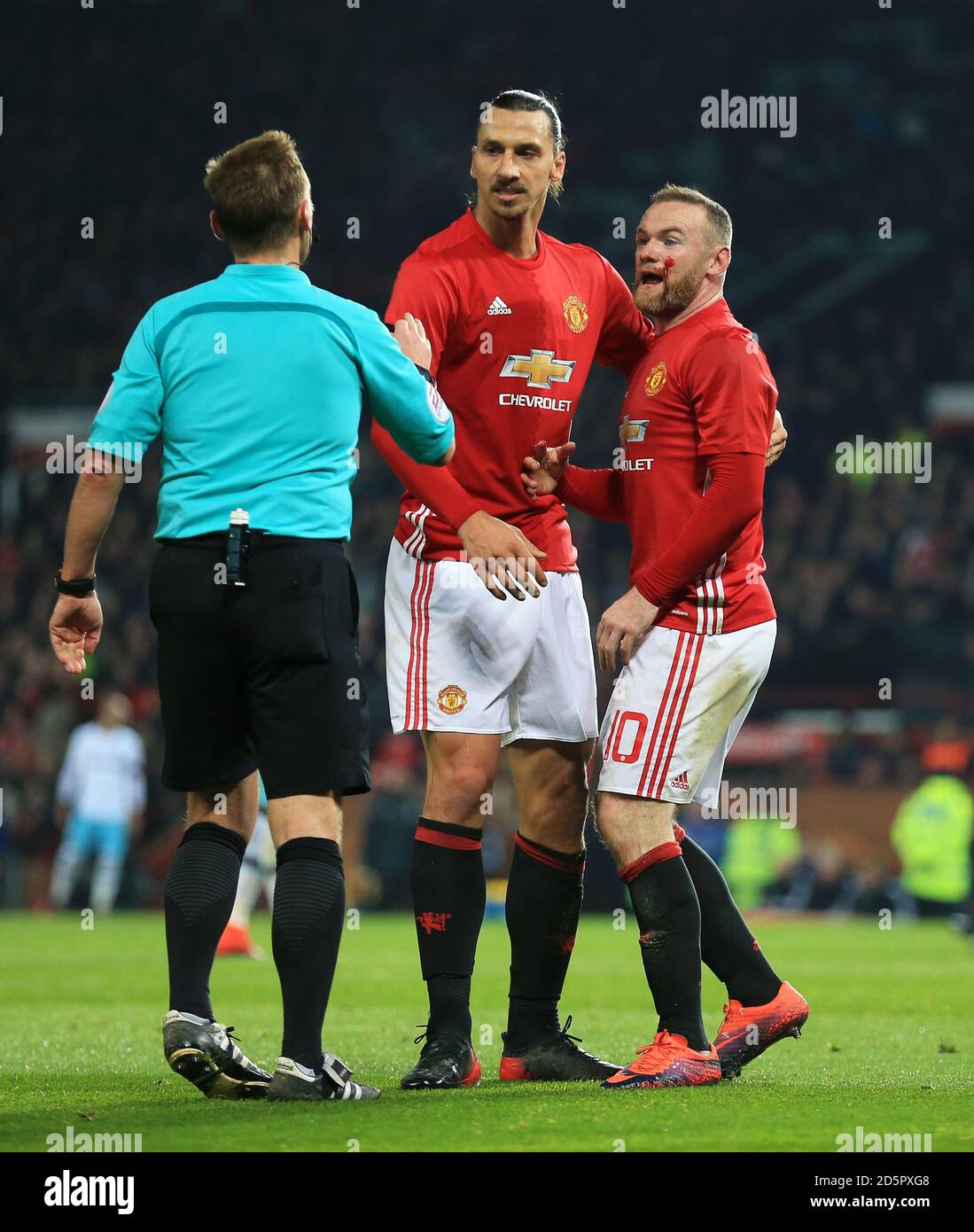 Manchester United's Wayne Rooney with blood on his face speaks with ...