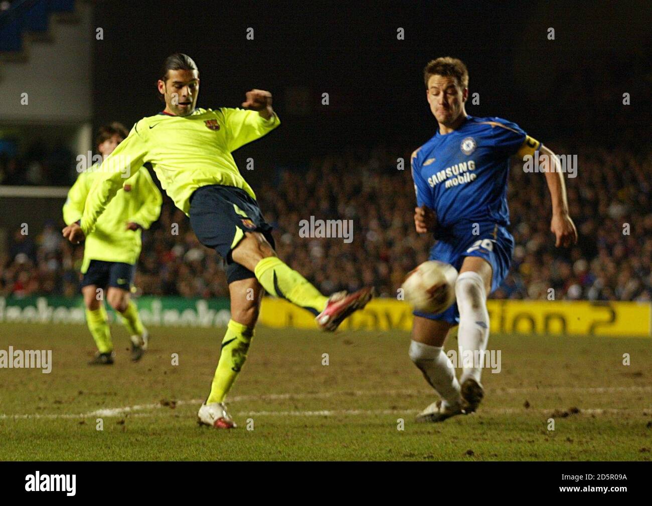 Barcelona's Rafael Marquez fires in a shot past Chelsea's John Terry ...