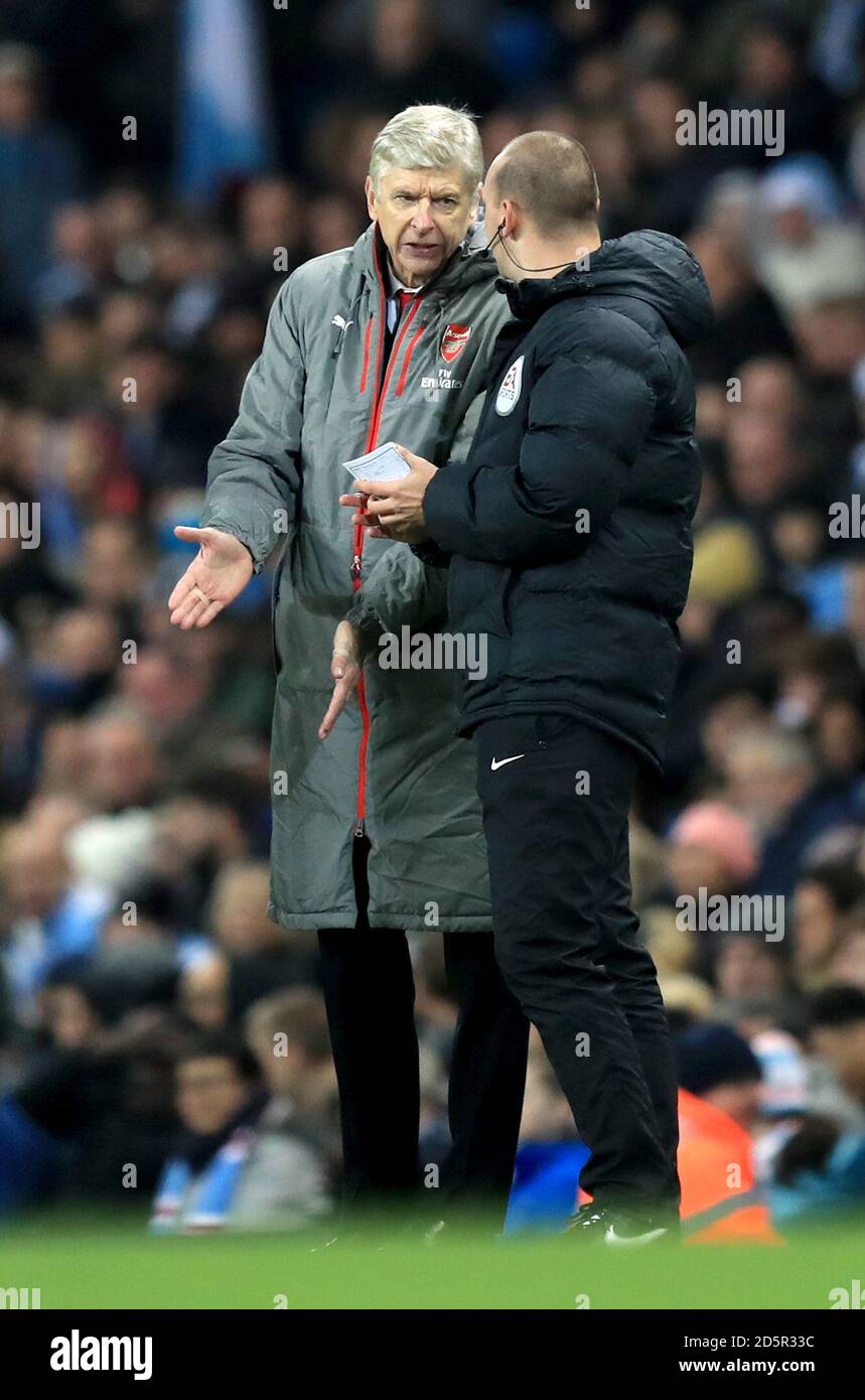 Arsenal manager Arsene Wenger (left) argues with the fourth official on ...