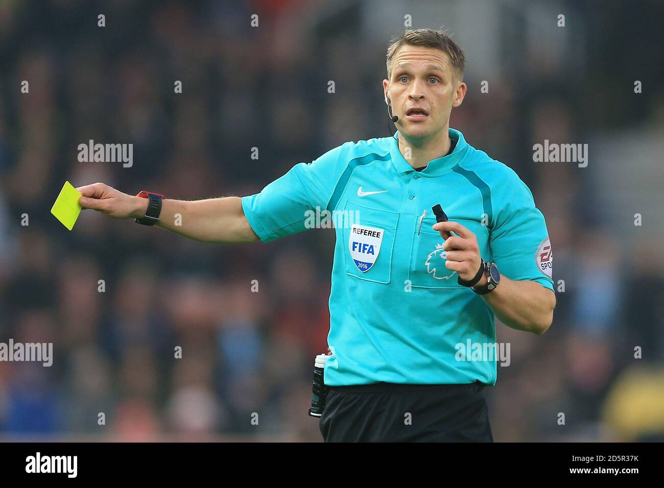 Referee Craig Pawson produces a yellow card Stock Photo - Alamy