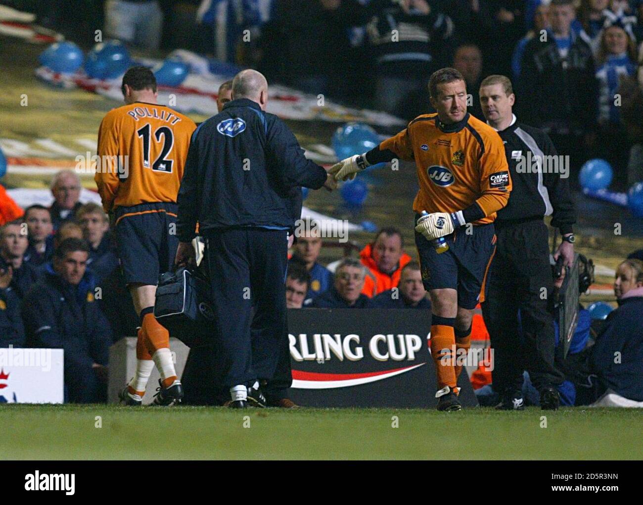 Wigan Athletic's injured goalkeeper Mike Pollitt is replaced by John ...