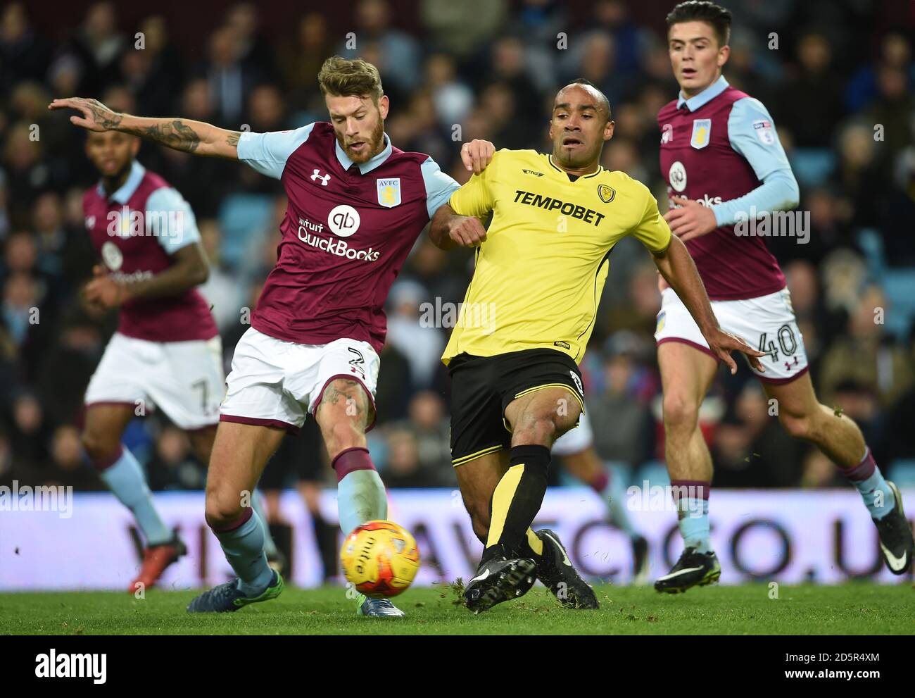 Aston Villa's Nathan Baker (left) and Burton Albion's Chris O'Grady (right) battle for the ball ...