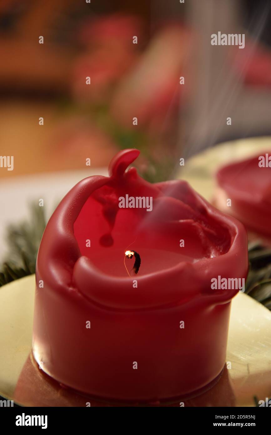 Blown out red christmas candle with smoke. Smoking red candle Stock ...