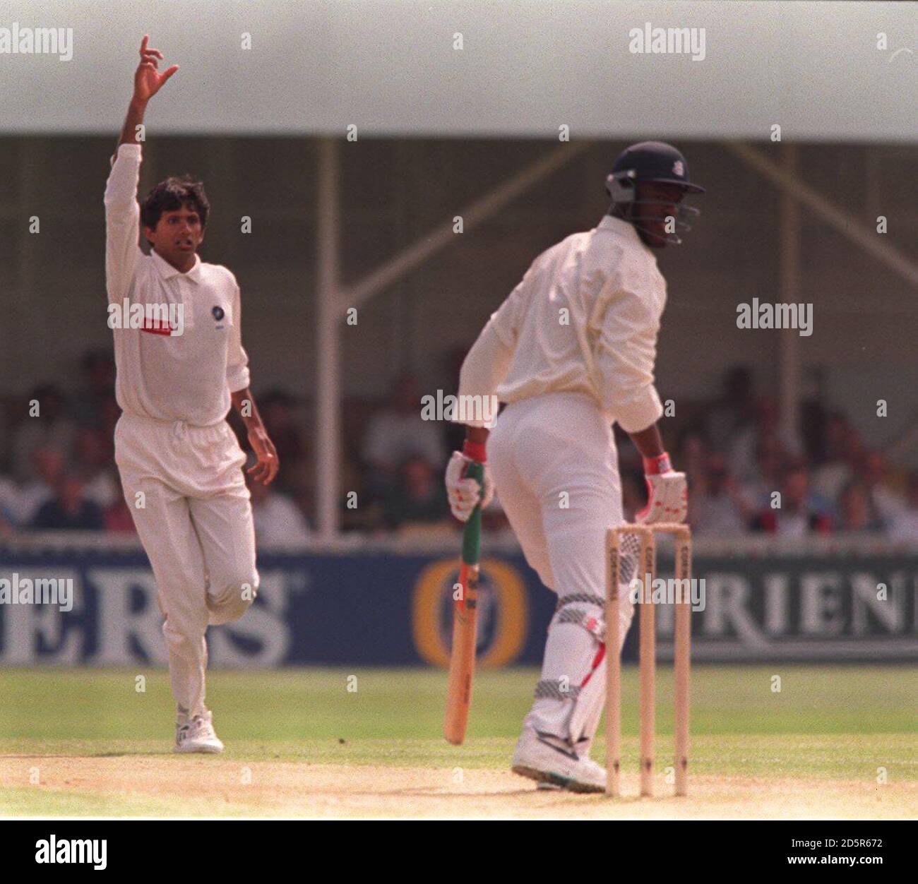 India's Venkatesh Prasad (left) has England's Chris Lewis (right ...