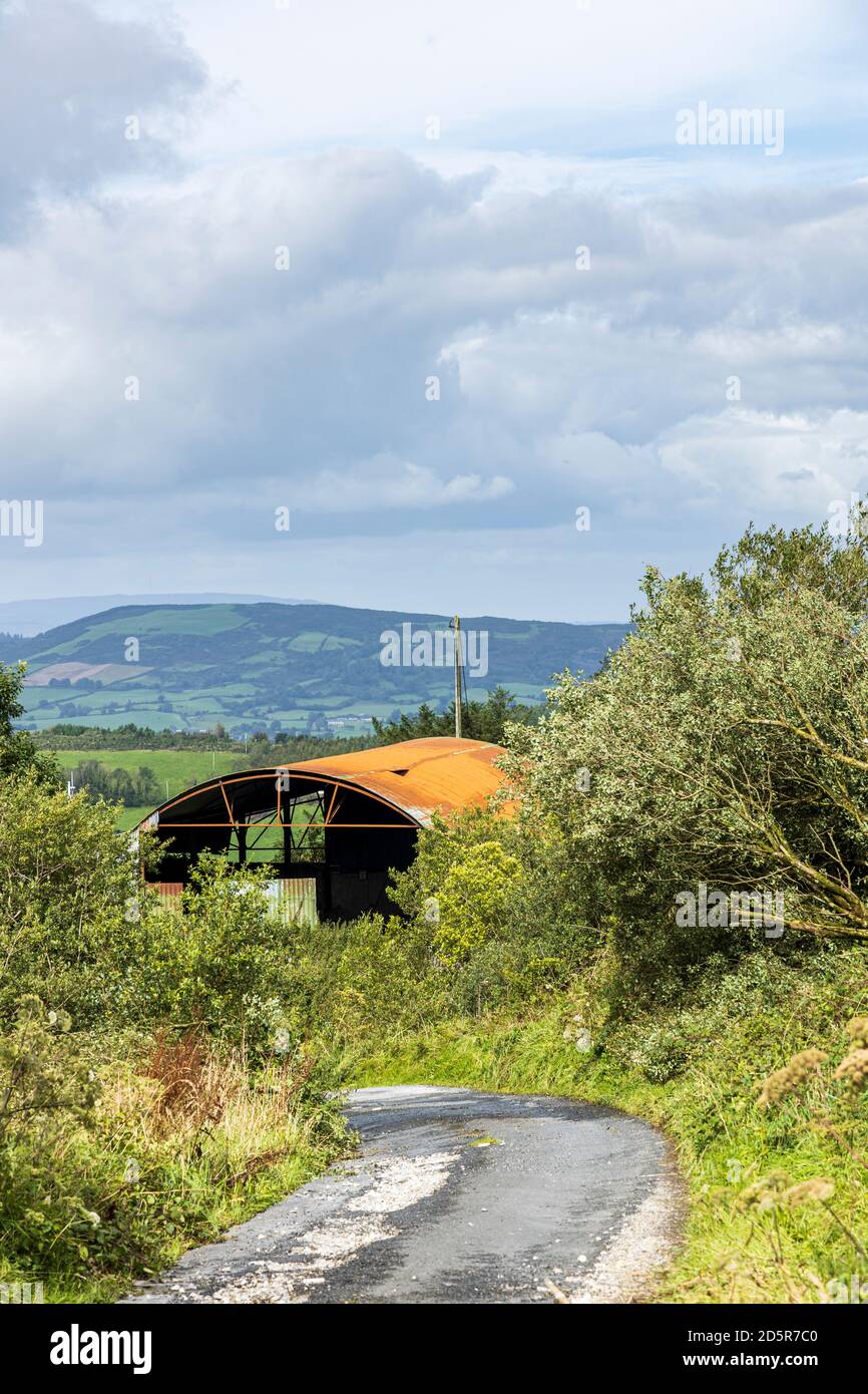 Red rusted corrugated iron roof on a barn at a farm on Tountinna, Tonn ...