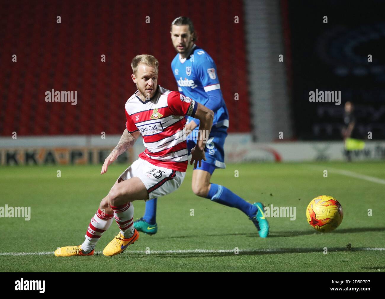 Doncaster Rovers' James Coppinger and Portsmouth's Christian Burgess ...