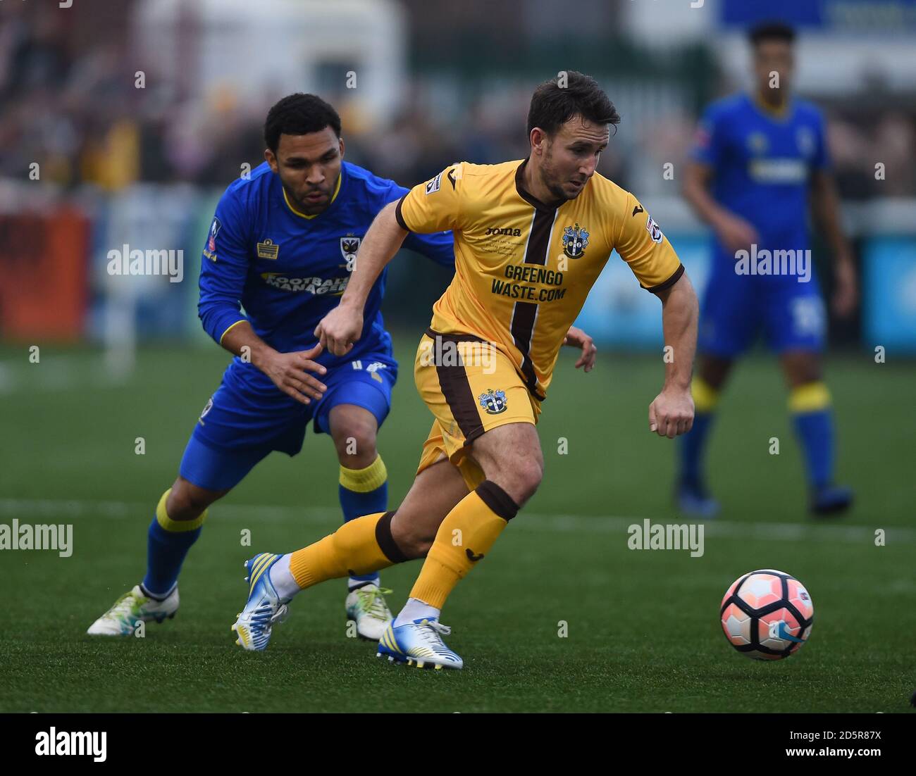Sutton United's Matt Tubbs gets past AFC Wimbledon's Andy Burcham Stock ...