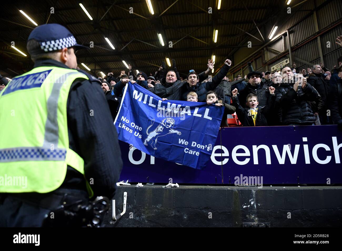 Millwall fans are watched by police officers Stock Photo - Alamy