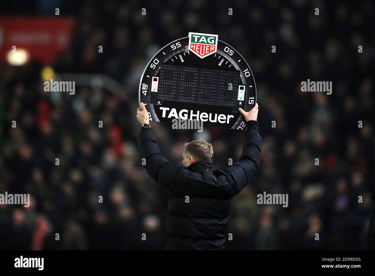 Fourth Official Graham Scott holds aloft the electronic board Stock ...