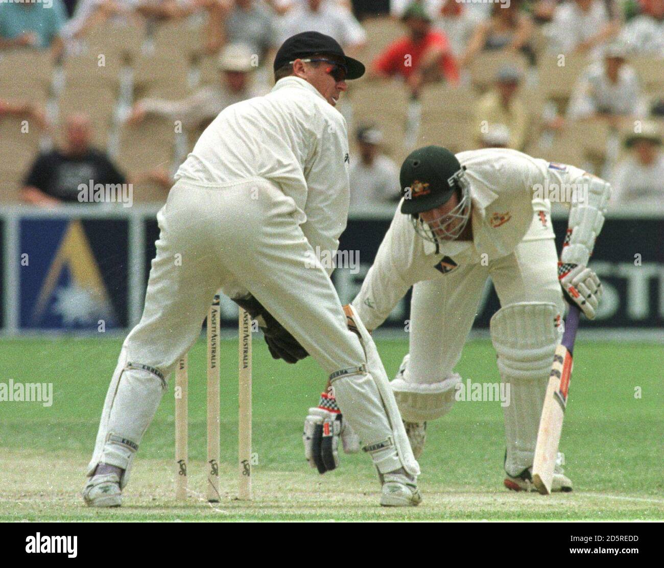Australia's Damien Fleming stumbles back into the crease infront of ...