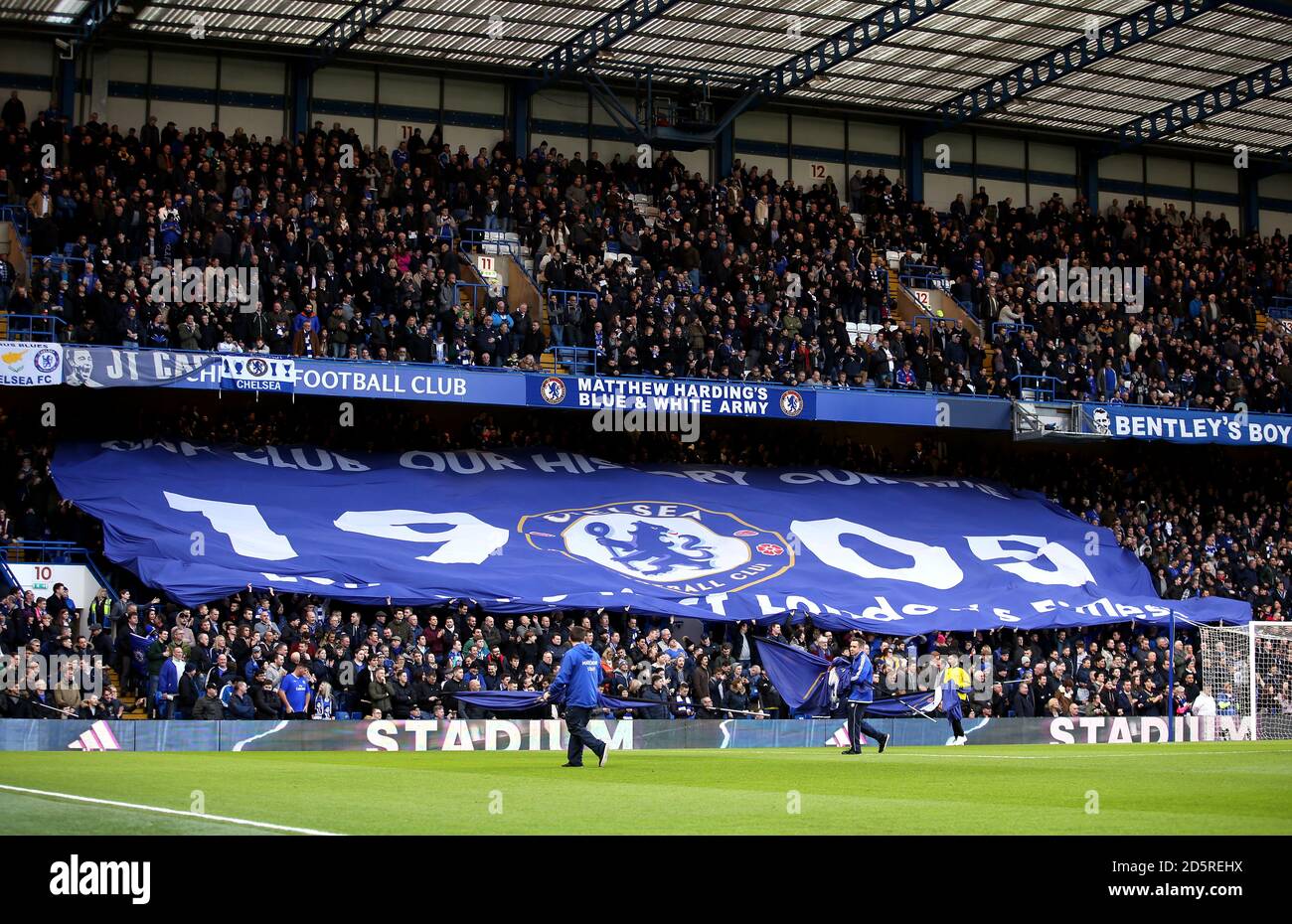Chelsea fans in the stands with a giant flag Stock Photo - Alamy