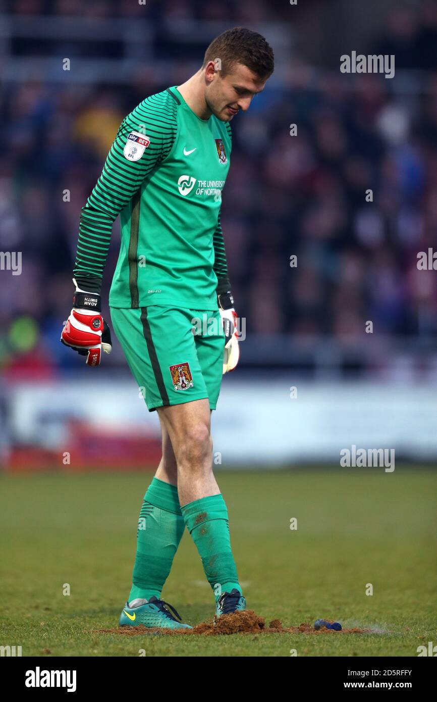 Northampton Town goalkeeper Adam Smith puts out a flare Stock Photo - Alamy