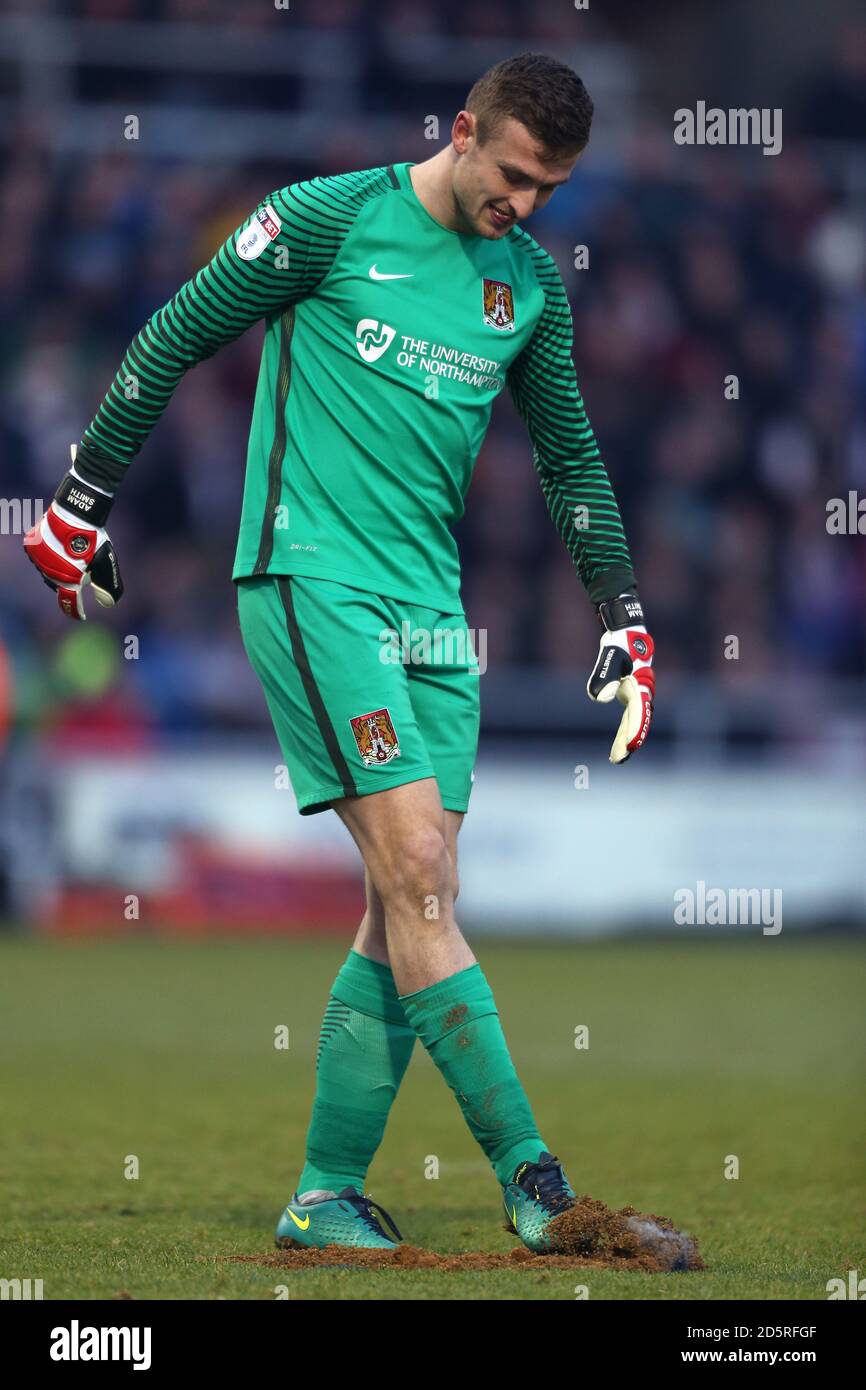 Northampton Town goalkeeper Adam Smith puts out a flare Stock Photo - Alamy