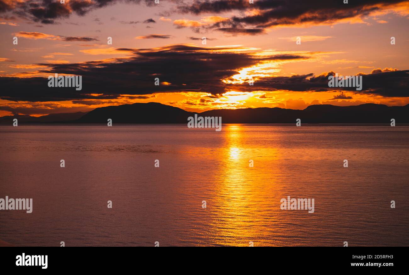 Summer Sunset over Alaska coast as seen from a boat on the water Stock ...