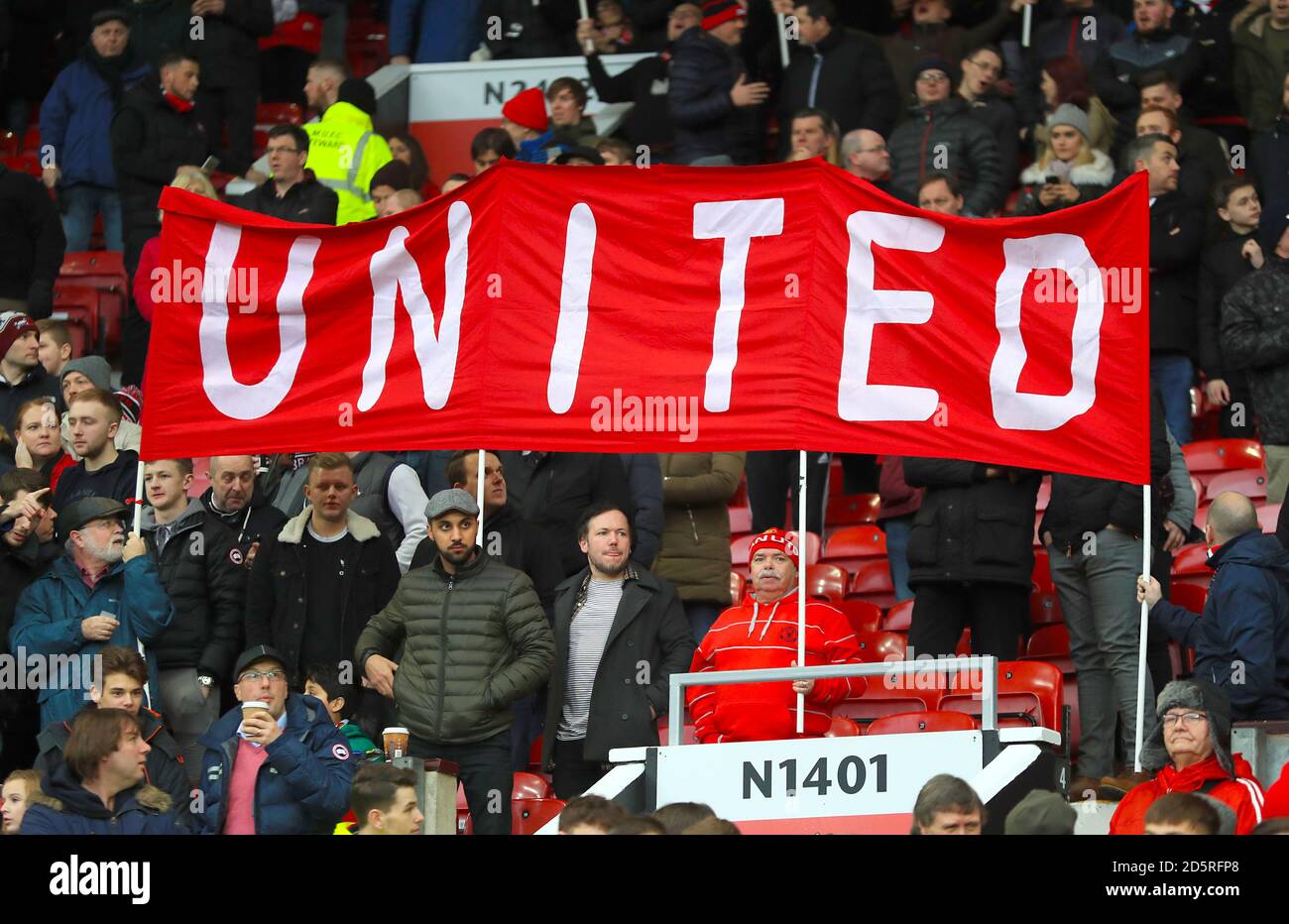 Manchester United fans hold a banner in the stands Stock Photo - Alamy
