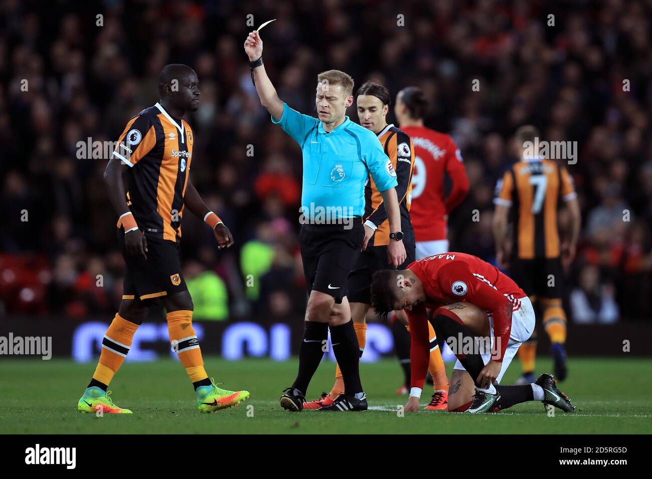 Hull City's Oumar Niasse (left) is shown a yellow card by referee Mike ...