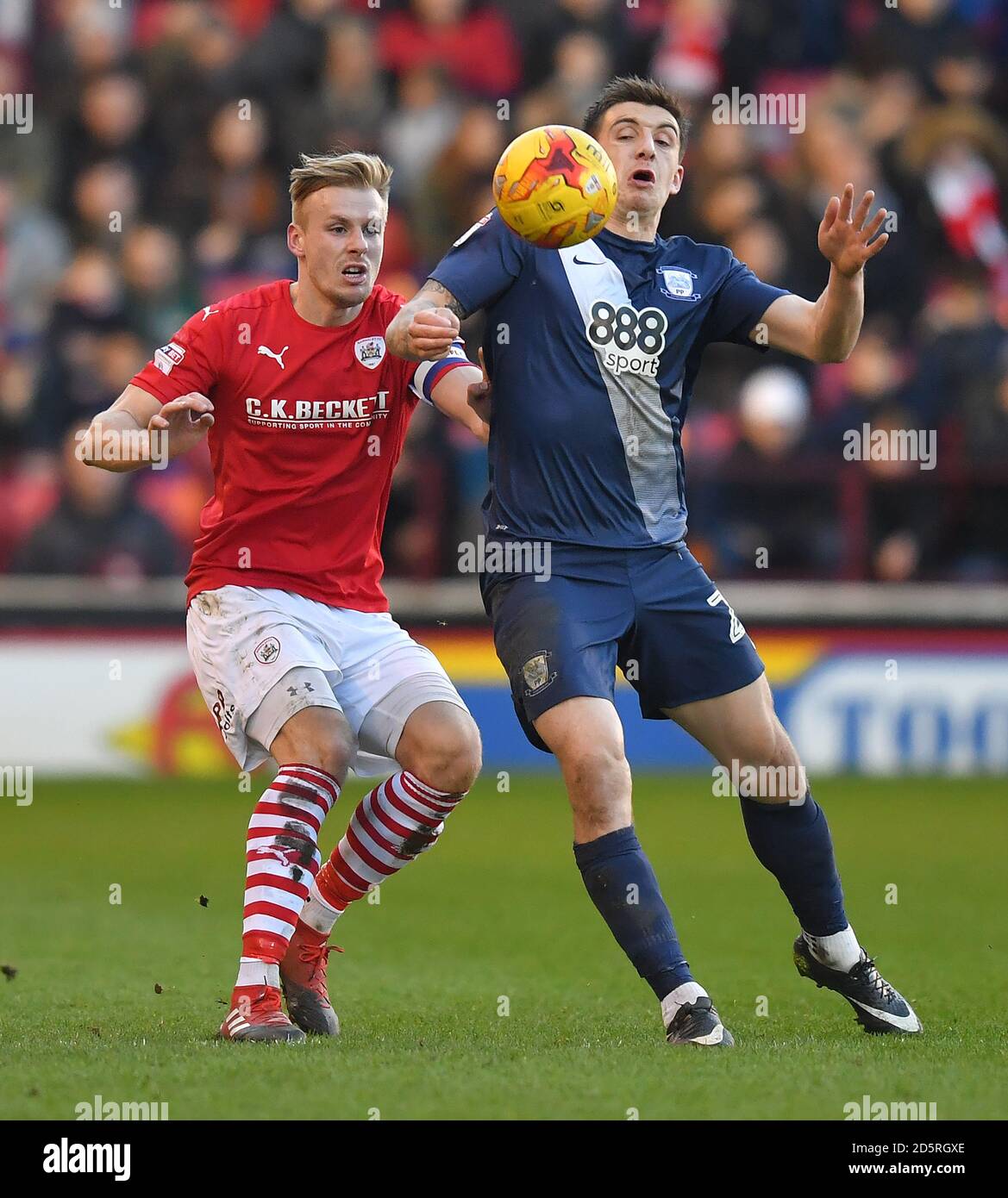 Preston North End's Jordan Hugill (right) battles with Barnsley's Marc ...