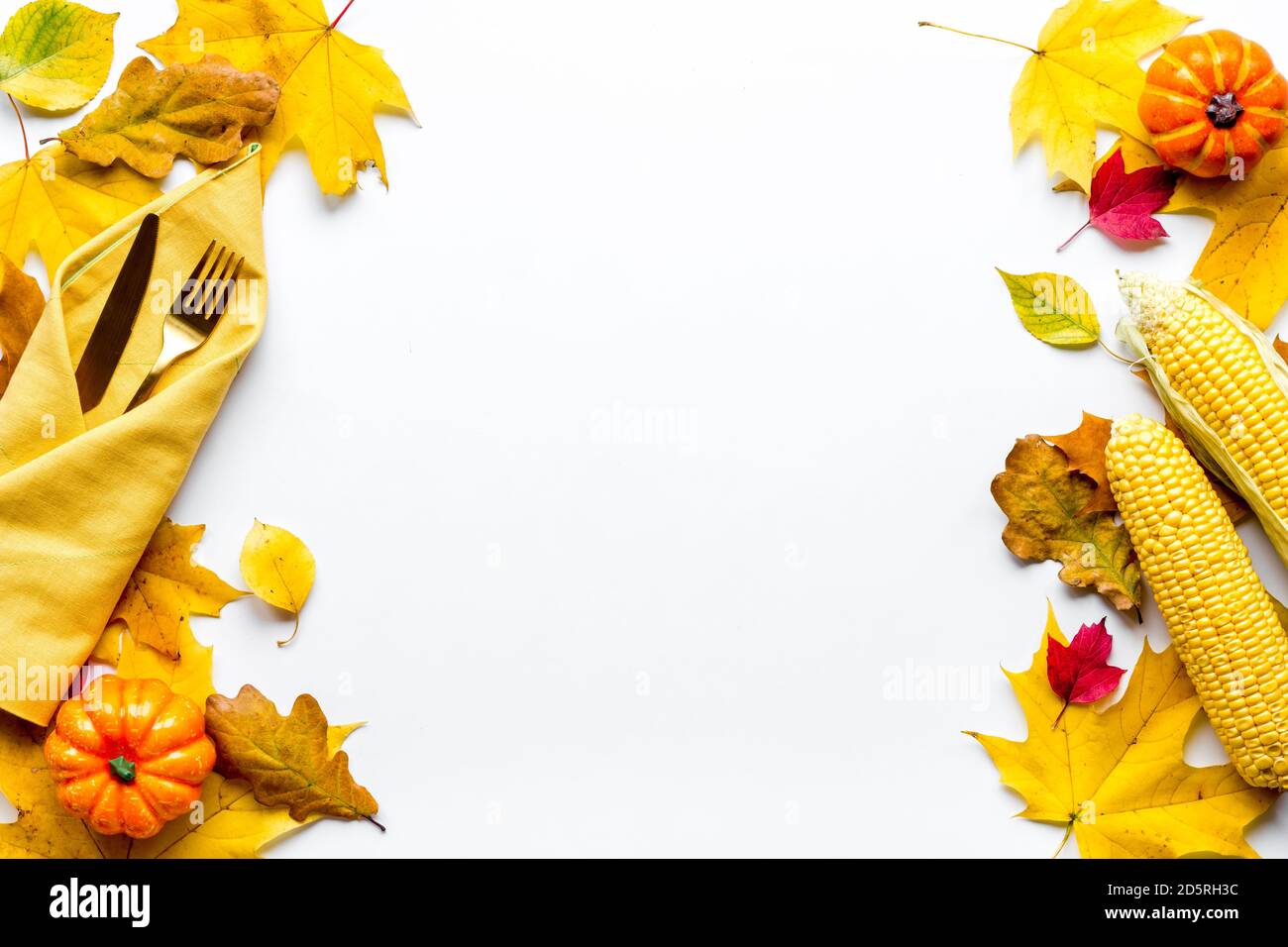 Thanksgiving dinner background with pumpkins leaves and cutlery, top ...