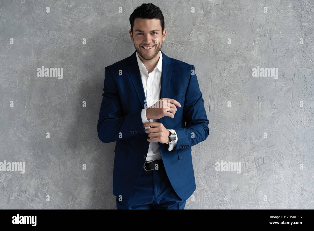 Handsome man wear blue suit isolated on grey background Stock Photo - Alamy