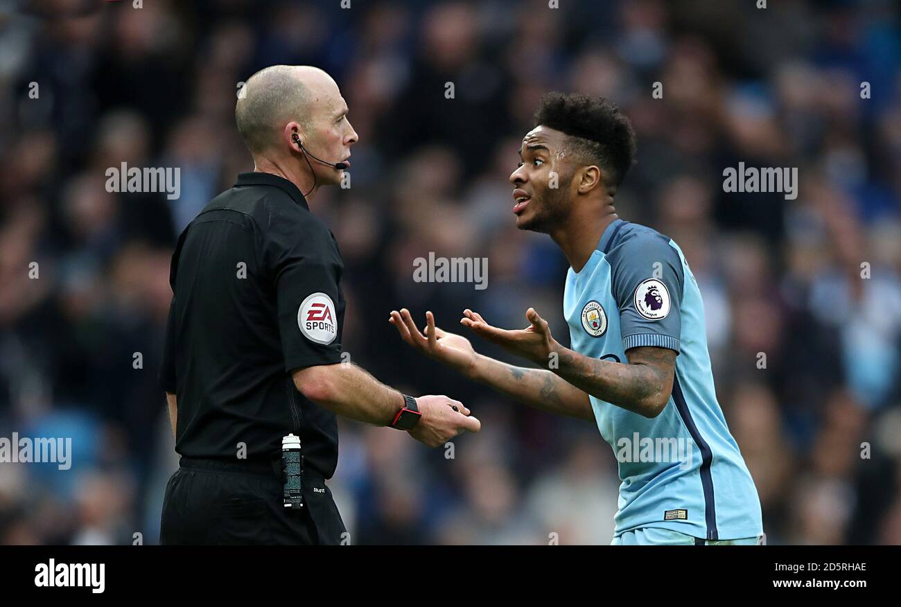 Manchester City's Raheem Sterling receives the yellow card from referee ...