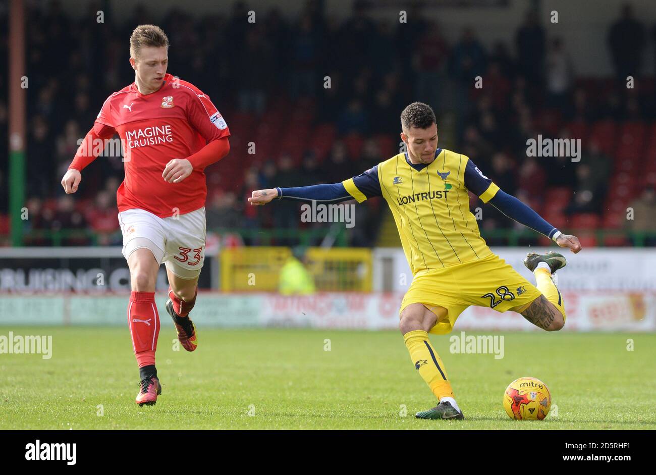 Swindon Town's Luke Norris (left) and Oxford United's Marvin Johnson in ...