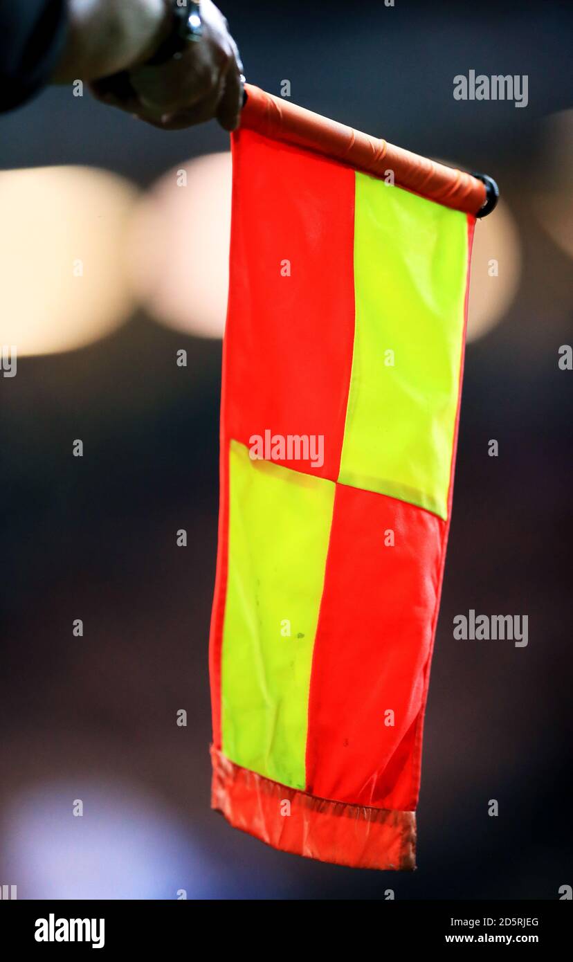 The linesman holds up his flag Stock Photo - Alamy