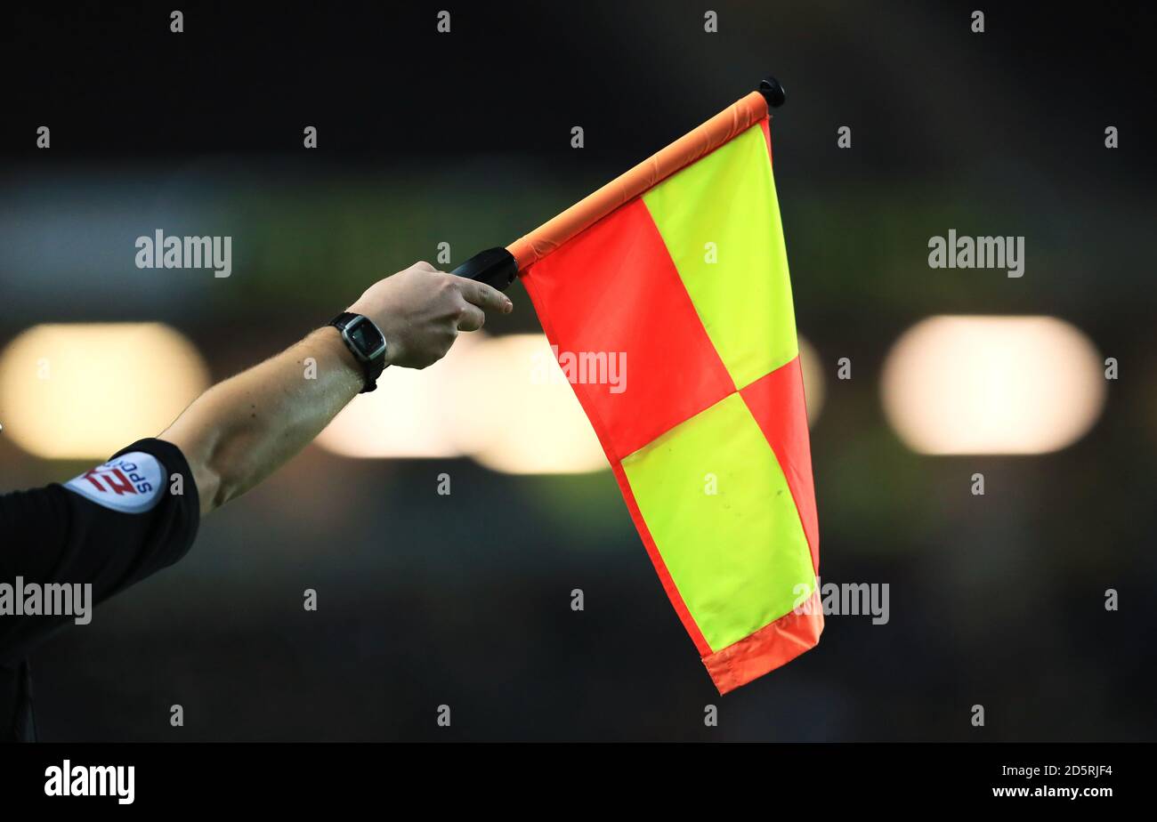 The linesman holds up his flag Stock Photo - Alamy