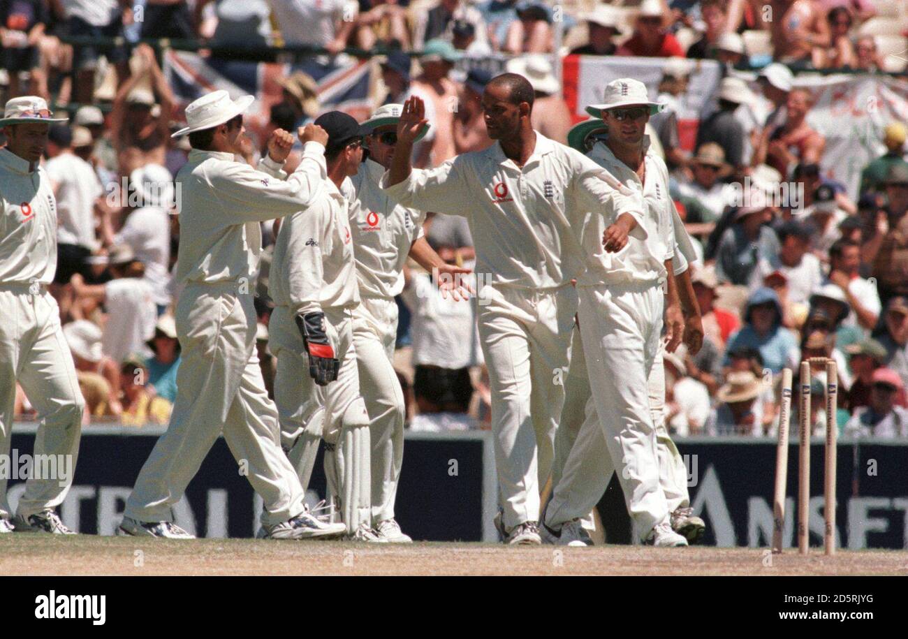 Team mates gather around England's Dean Headley after the wicket of ...