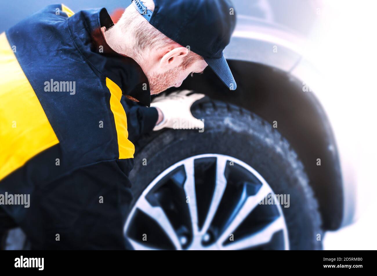 Mechanic repairing a car wheel.Male mechanic at a car garage fixing a ...