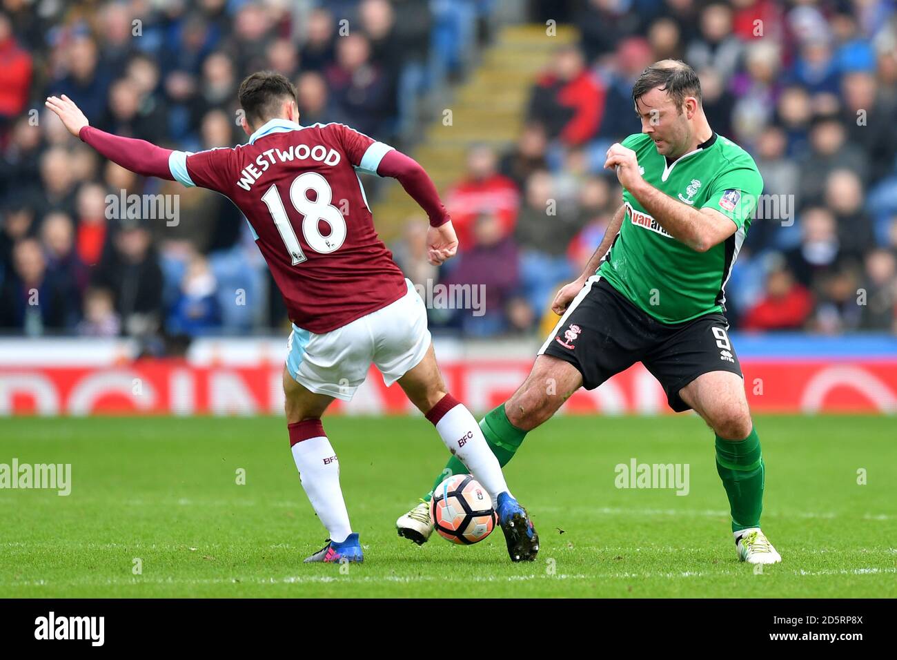 Burnley's Ashley Westwood (left) and Lincoln City's Matt Rhead battle ...