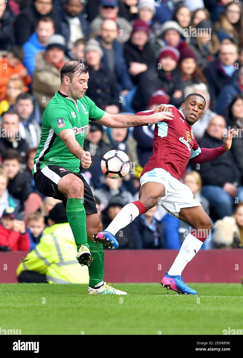 Burnley's Tendayi Darikwa (right) and Lincoln City's Matt Rhead battle ...