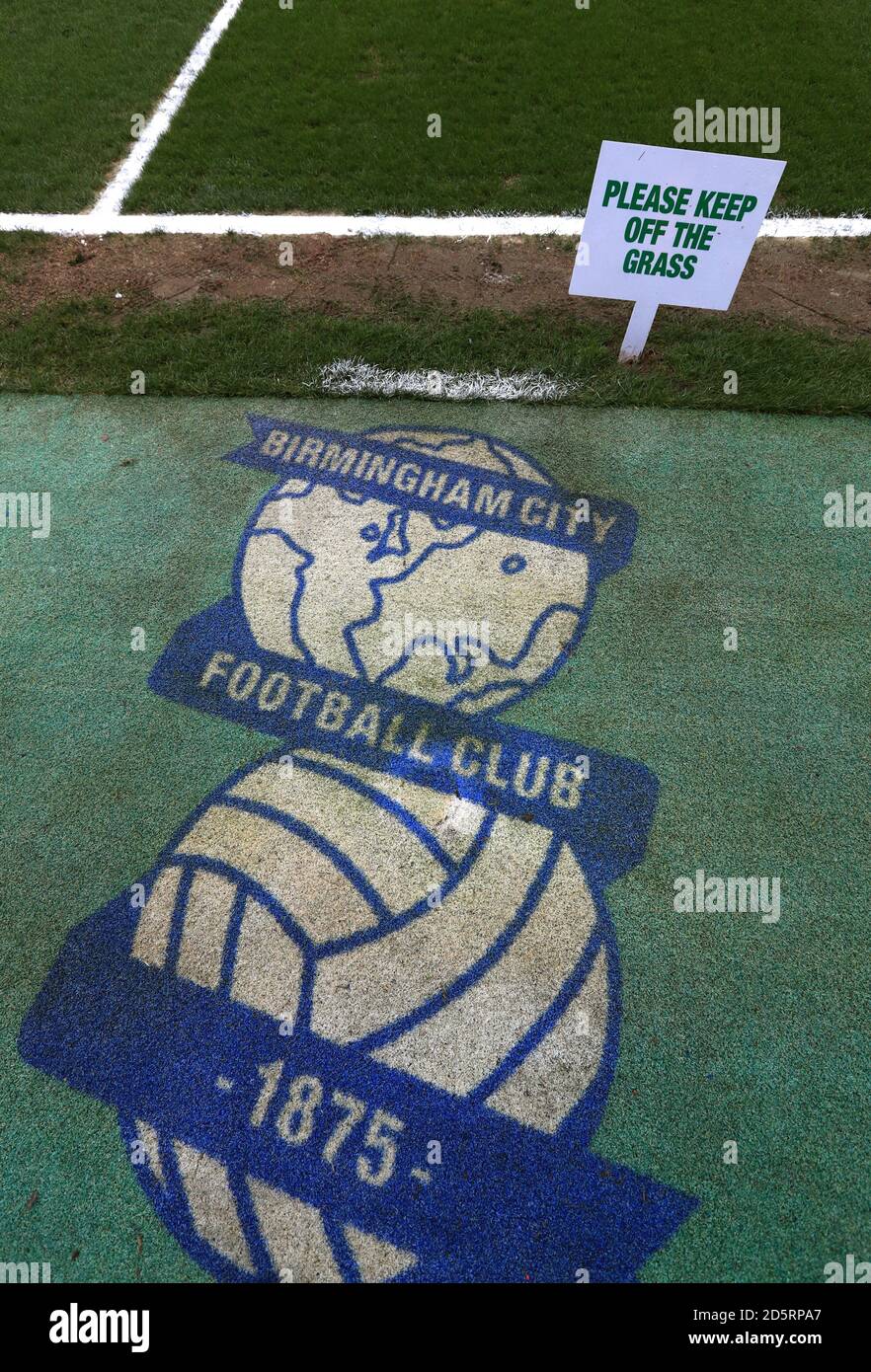 The Birmingham City crest pitchside next to a keep off the grass sign ...