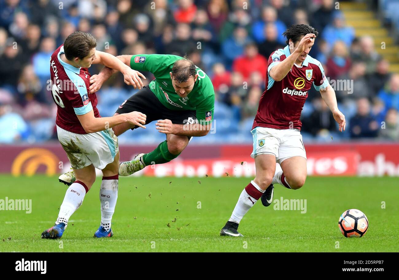 Lincoln City's Matt Rhead (centre) reacts to a challenge from Burnley's ...