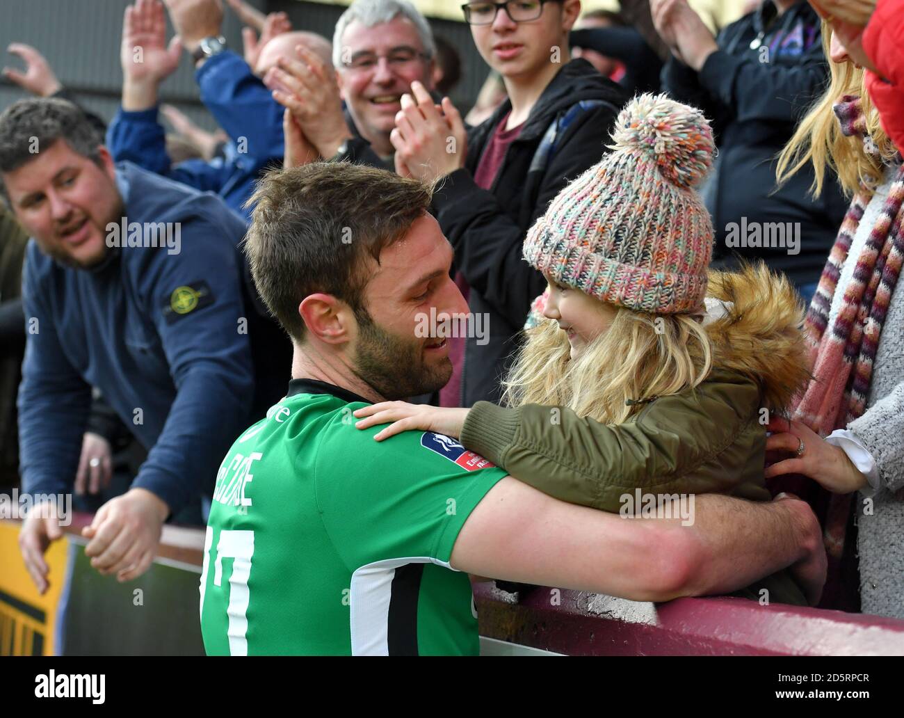 Lincoln City's Jamie McCombe celebrates with his family after the final ...