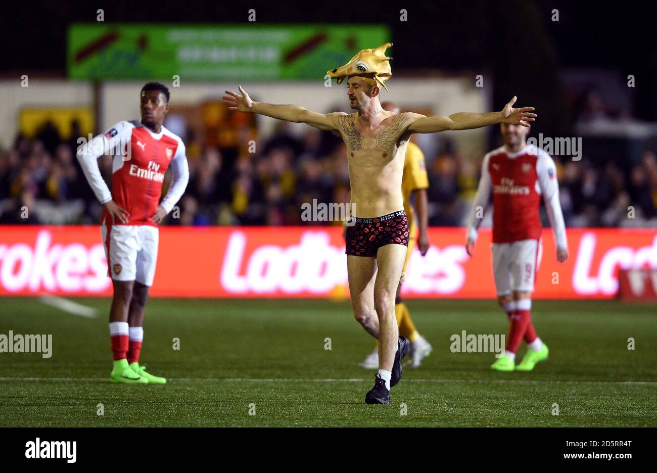 A pitch invader wearing a Giraffe mask and boxer shorts with lips on ...