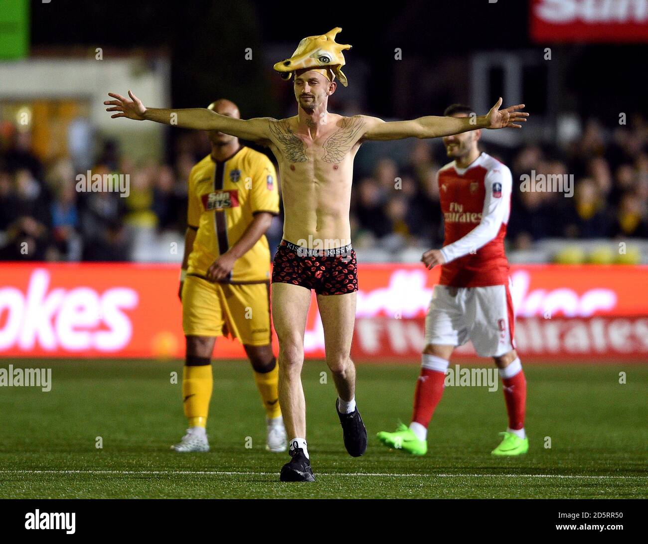 A pitch invader wearing a Giraffe mask and boxer shorts with lips on ...