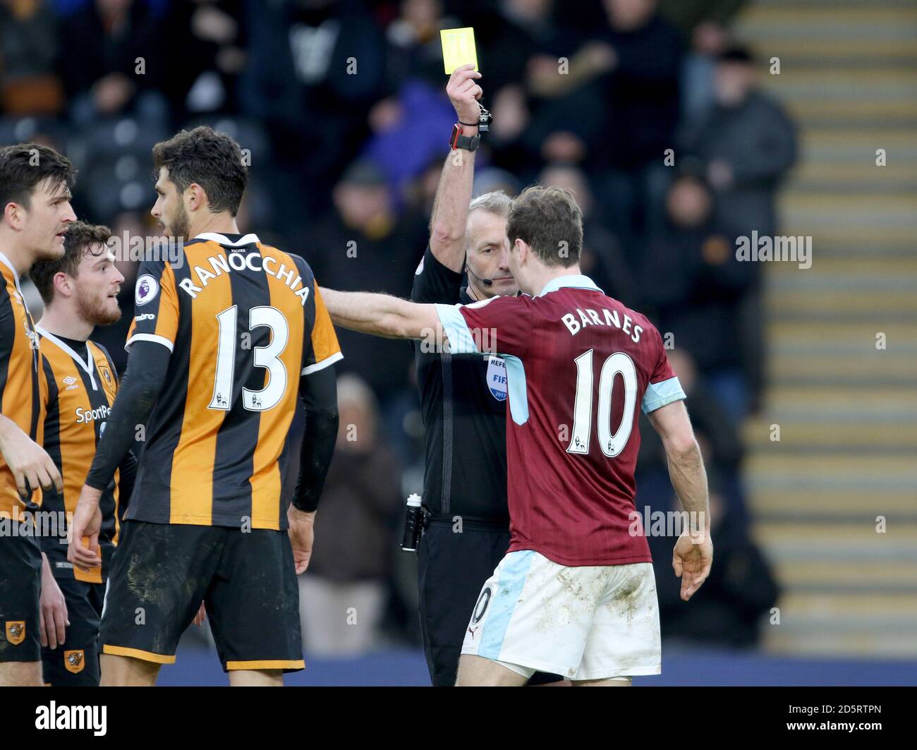 Burnley's Ashley Barnes shown yellow card by referee Martin Atkinson ...