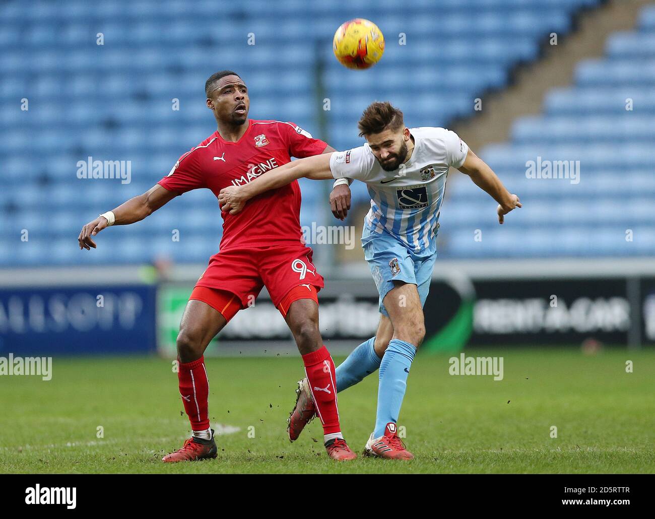 Coventry City's Jordan Turnbull and Swindon Town's Jonathan Obika Stock ...