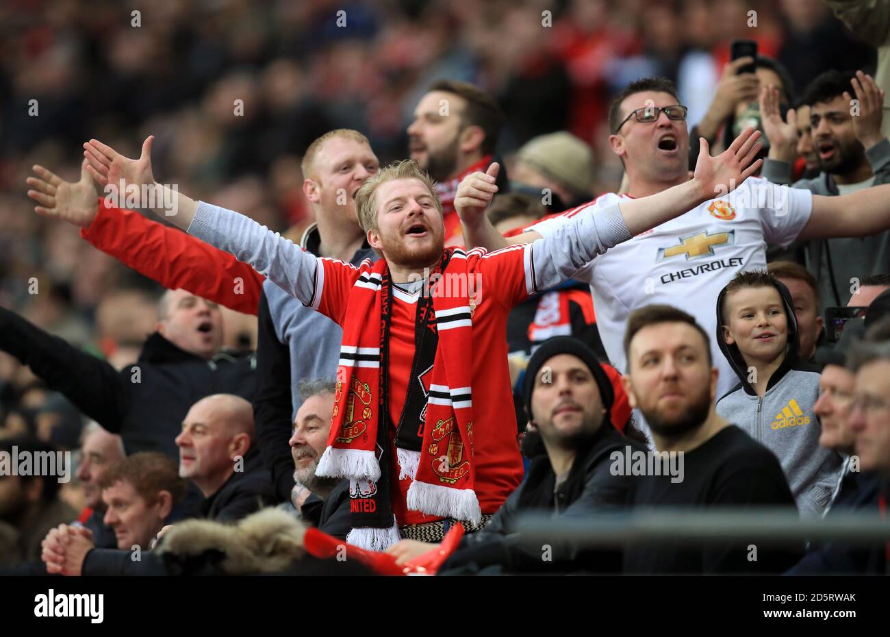 Manchester United fans in the stands show their support Stock Photo - Alamy