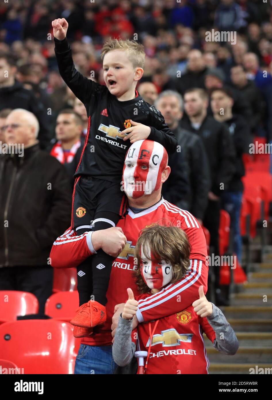 Manchester United fans in the stands show their support Stock Photo - Alamy