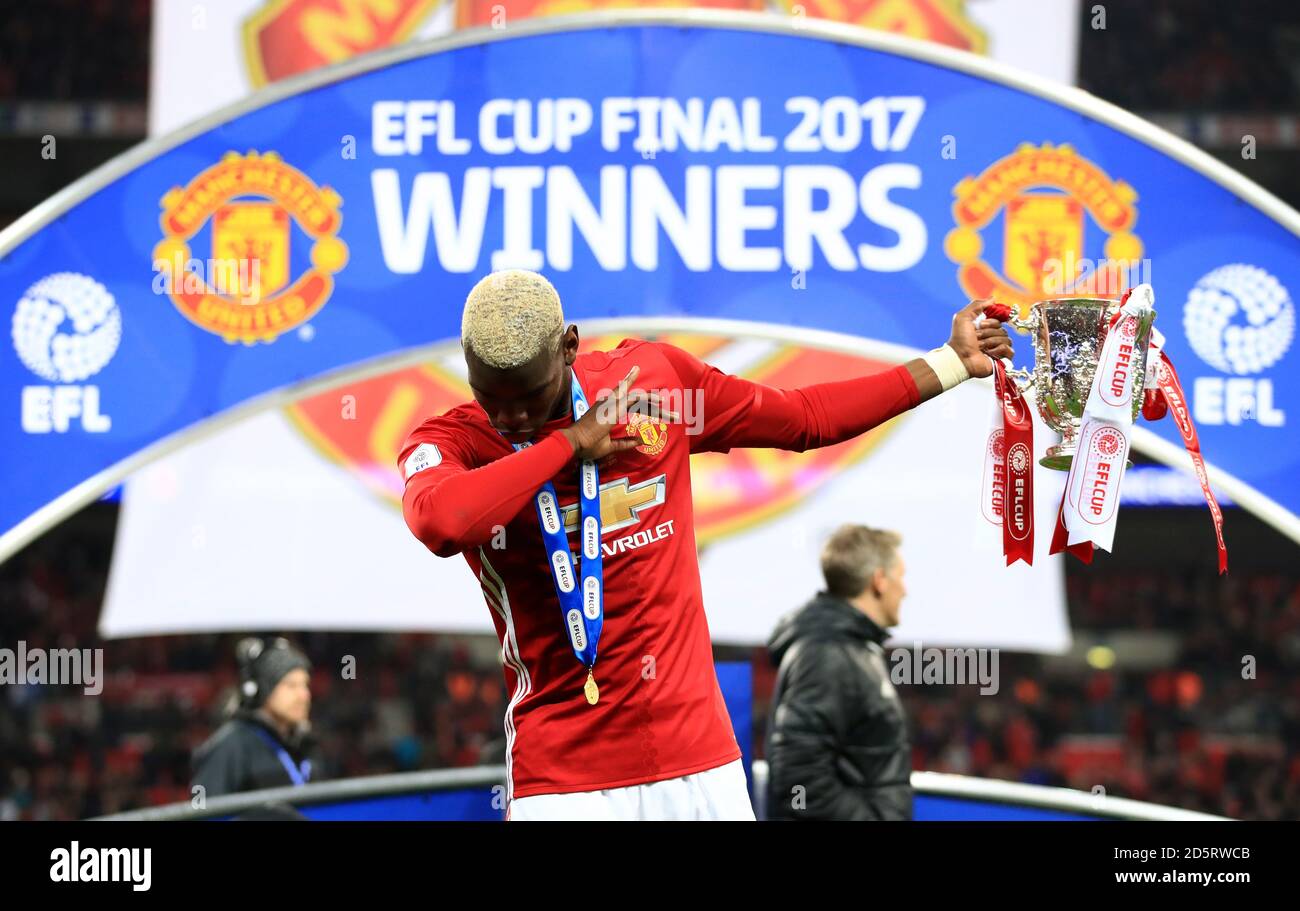 Manchester United's Paul Pogba celebrates with the EFL Cup Trophy Stock ...