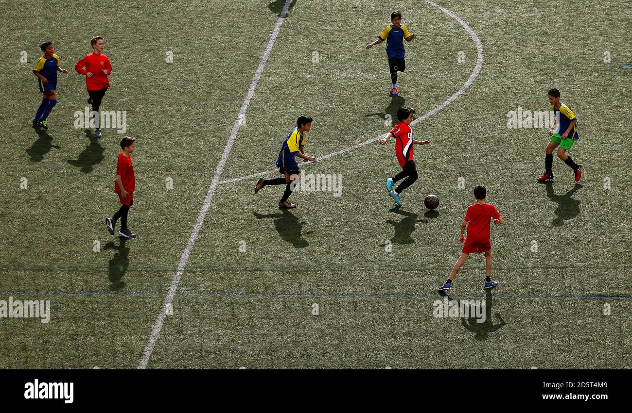 General view of local children playing football on astroturf pitch in ...