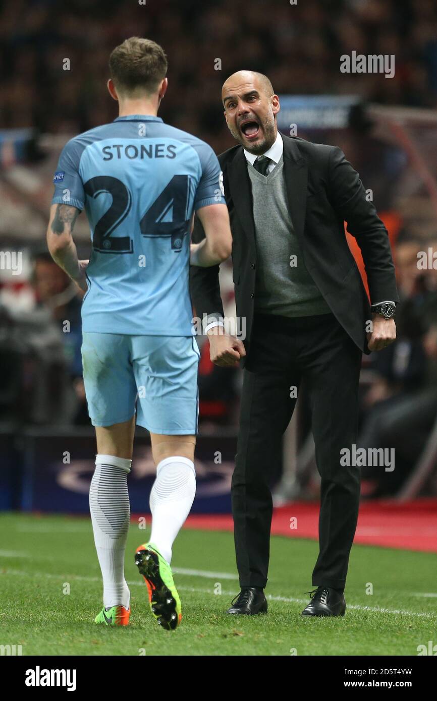 Manchester City manager Pep Guardiola (right) gives instructions to ...
